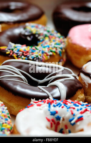 assorted donuts with chocolate frosted, pink glazed donuts Stock Photo ...