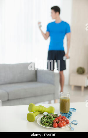 Dumbbells with tape measure, vegetable salad, bread, grilled pork neck ...