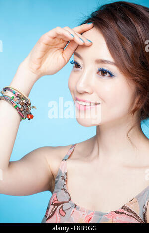 Woman in summer outfits putting her hand on her forehead with a smile ...