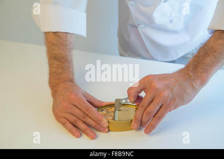 Chef opening a can Stock Photo - Alamy