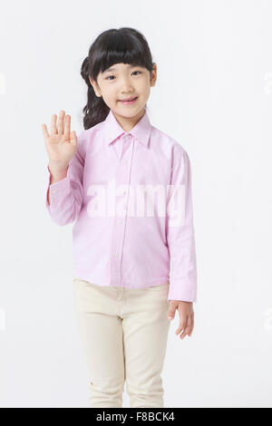 Cute smiling woman waving hand to greet you, saying hello with shy grin ...