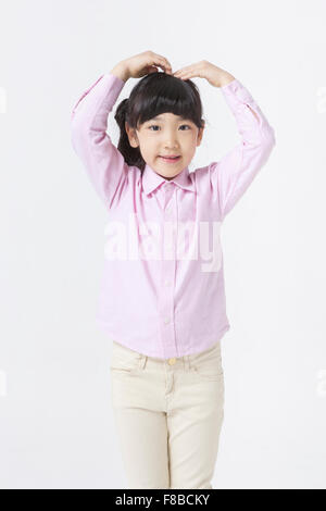 Asian girl with pink hair making fun while eating chewing marmalade ...