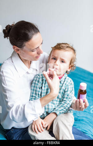 2 year old boy taking syrup with pipette Stock Photo - Alamy