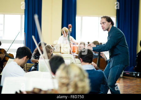 Music education: A young male conductor in a conducting masterclass ...