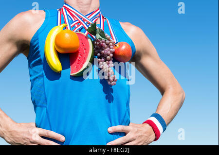Winner of healthy eating competition standing at running track with ...