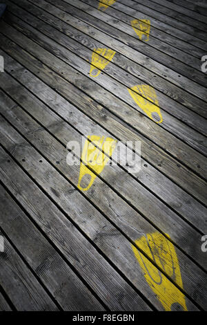 Yellow footprints on pier Stock Photo - Alamy