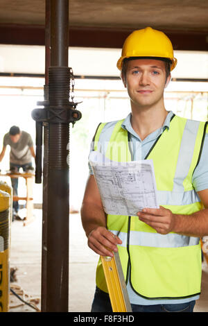 Portrait Of Builder On Site With Plans Stock Photo - Alamy