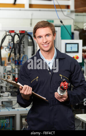 Engineer Inspecting Component In Factory Stock Photo - Alamy