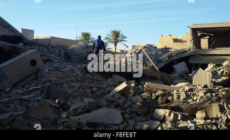 Fallujah, Iraq. 9th Dec, 2015. A man stands in front of destroyed ...