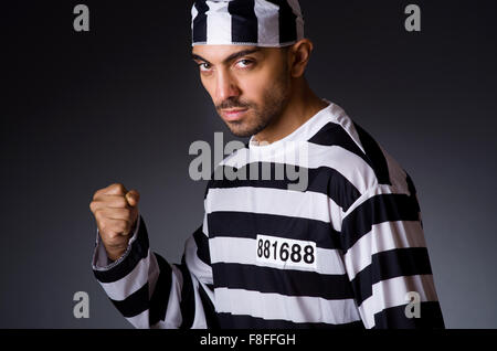 Angry prison inmate in dark room Stock Photo - Alamy
