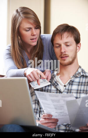 Couple arguing about home finance and calculating family budget in ...