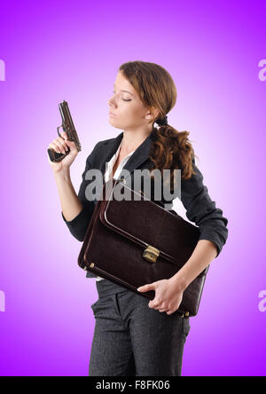 Woman businewoman with hand gun Stock Photo - Alamy