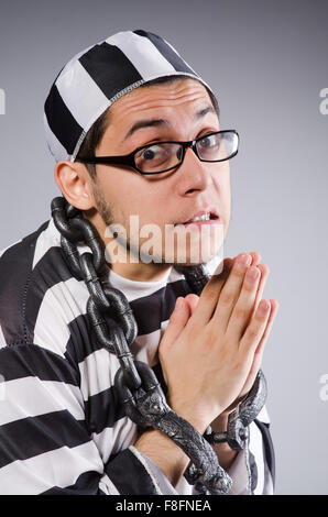 Funny prisoner in chains isolated on gray Stock Photo - Alamy