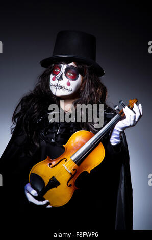 Monster playing violin in dark room Stock Photo - Alamy