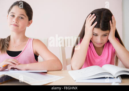 Caucasian twin sisters doing homework Stock Photo - Alamy