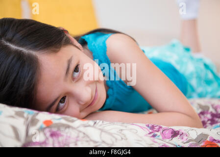 Girl laying on bed Stock Photo - Alamy