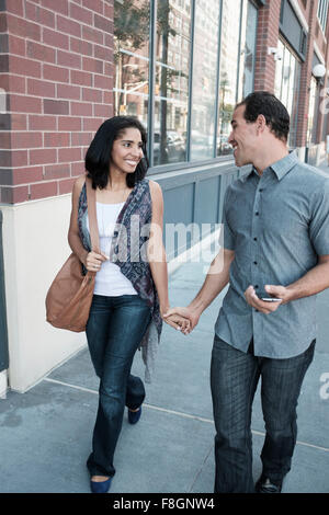 Two women talking outside while walking. African friends in ...