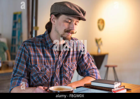 People reading in coffee bar, Islington, London Stock Photo - Alamy
