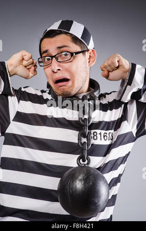Funny prisoner in chains isolated on gray Stock Photo - Alamy