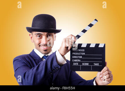 Man with movie clapper against the gradient Stock Photo - Alamy