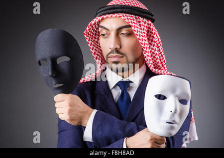 Arab with masks in dark studio Stock Photo - Alamy