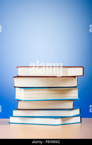 Stack of text books against gradient background Stock Photo - Alamy