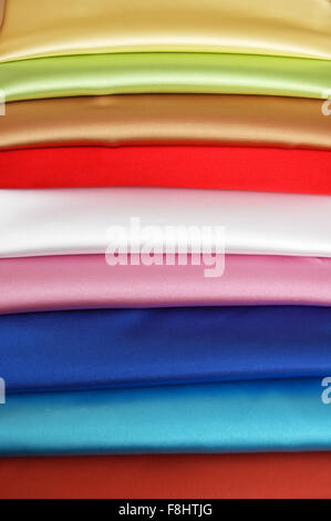 Stack of satin fabric of various colours Stock Photo - Alamy