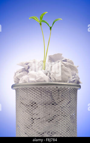 Green seedlings growing out of paper Stock Photo - Alamy