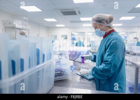 Workers pack surgical instruments in clean room of surgical instruments ...