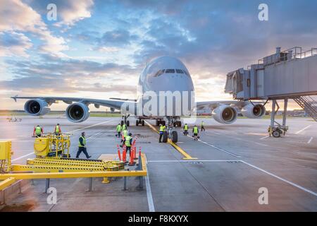 Ground crew attending to A380 aircraft at airport Stock Photo - Alamy