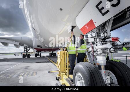 Ground crew operating loading equipment on A380 aircraft Stock Photo ...