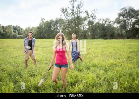 Group of young adults playing badminton in field Stock Photo - Alamy