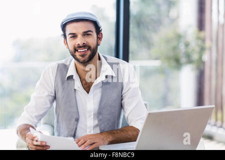 Young caucasian man holding document working at office Stock Photo - Alamy