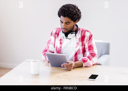 Handsome man using tablet on white background Stock Photo - Alamy