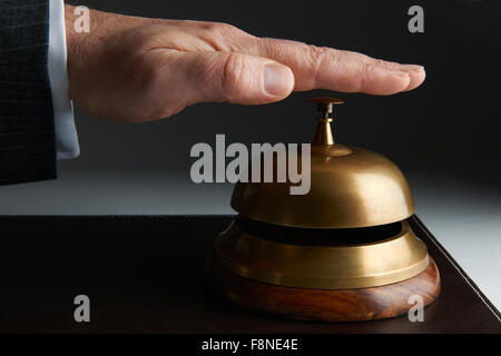 Man ringing service bell on reception desk in hotel Stock Photo - Alamy