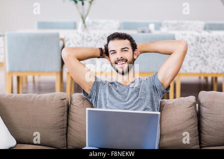 Handsome man relaxing in sofa at home Stock Photo - Alamy