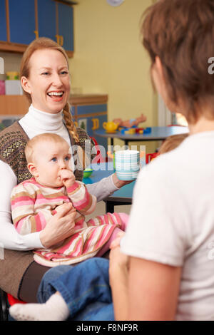 Mothers With Babies Chatting And Drinking Coffee At Playgroup Stock ...