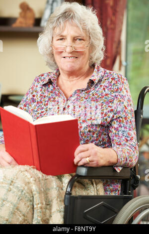 Senior caucasian woman reading a book over isolated background very ...