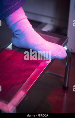 Patient foot in red physiotherapy heat treatment under hot light Stock ...
