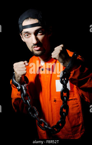 Inmate chained on black background Stock Photo - Alamy