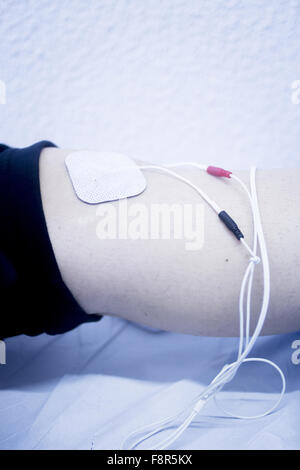 Patient leg and knee in electro physiotherapy electrical impulse ...