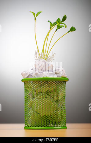 Green seedlings growing out of paper Stock Photo - Alamy