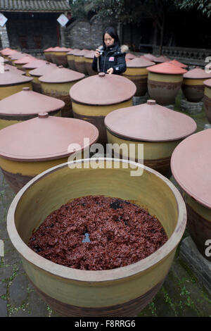 Pixian chilli bean paste maturing in earthenware vats in a yard in ...