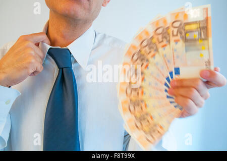 Man fanning himself with bank notes Stock Photo - Alamy
