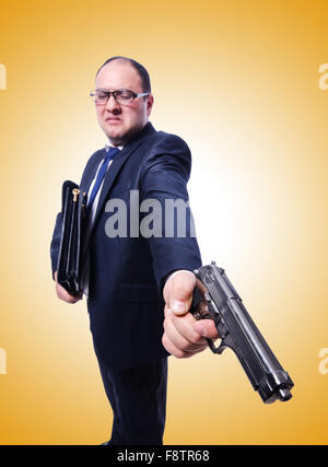 Businessman with gun against the gradient Stock Photo - Alamy