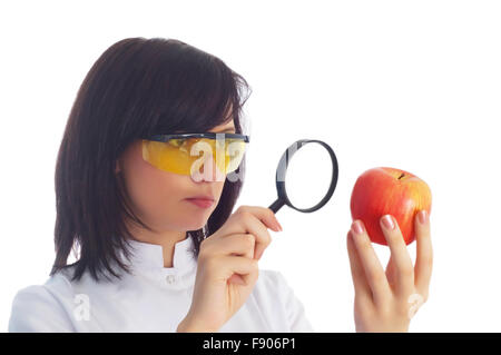 Female scientist looking at apple through magnifying lens Stock Photo ...