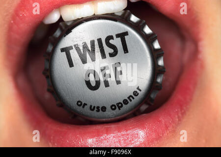 twist off beer cap in womans mouth Stock Photo - Alamy