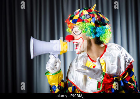 Clown in studio with loudspeaker Stock Photo - Alamy