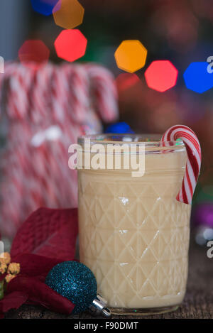 Christmas decoration with an old time milk can with tree boughs and ...