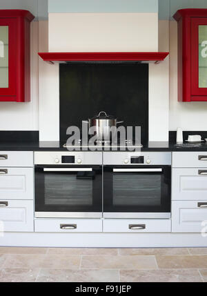 Interior of light kitchen with modern cupboards and appliances located ...